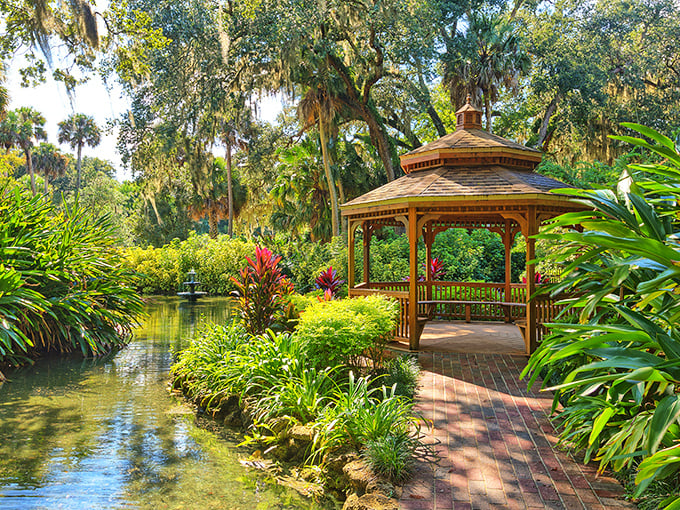 This gazebo knows how to make an entrance – surrounded by tropical blooms like a movie star at a premiere.