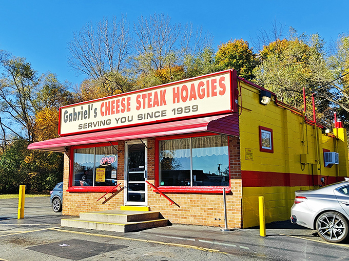 Fall colors frame this cheery yellow sandwich shop – a Philly cheesesteak paradise hiding in plain sight.