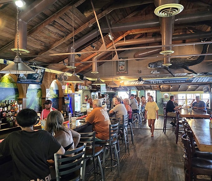 Inside, rustic wooden beams and mounted gators create that perfect "Old Florida" vibe where conversations flow as freely as the drinks.