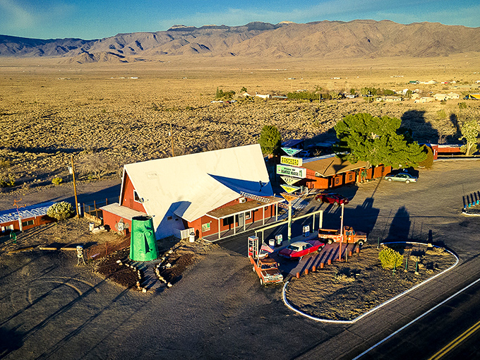 From above, the A-frame visitor center and its emerald sentinel appear like a mirage in the vast Arizona desert—a quirky oasis for road-weary travelers.