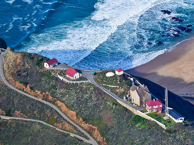 From above, the lighthouse compound reveals itself as a tiny civilization perched between mountain and sea—California's most dramatic cul-de-sac.