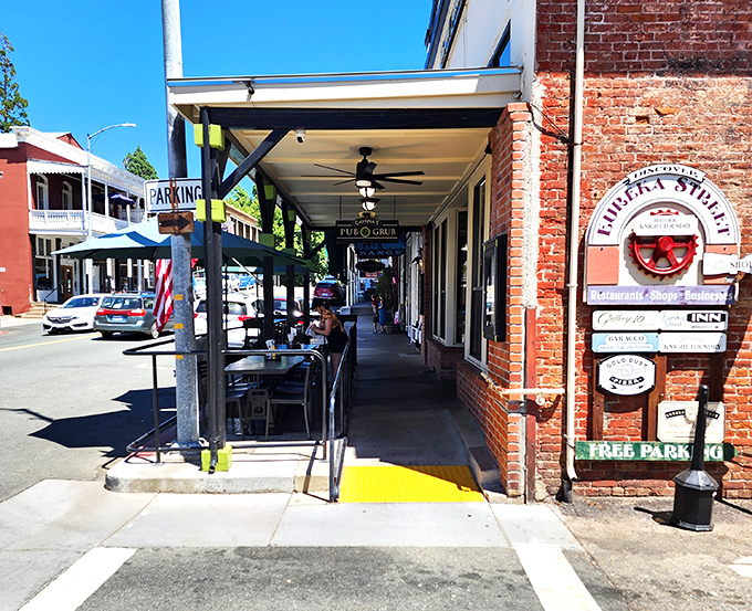 Shaded sidewalks and brick buildings create the perfect backdrop for afternoon people-watching. The Eureka Street sign promises discoveries that would make any gold prospector jealous.
