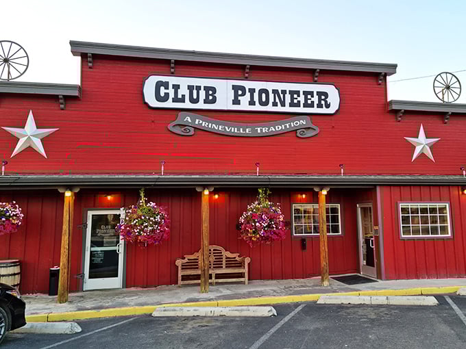 Club Pioneer's vibrant red exterior isn't just a building—it's a beacon calling hungry travelers home with the promise of Western hospitality and hearty meals.