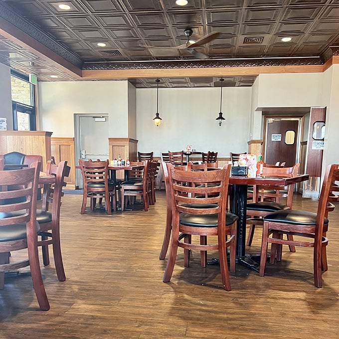 Warm wood tones and classic ladder-back chairs invite you to settle in. This isn't fast food territory—it's a place where conversations happen.