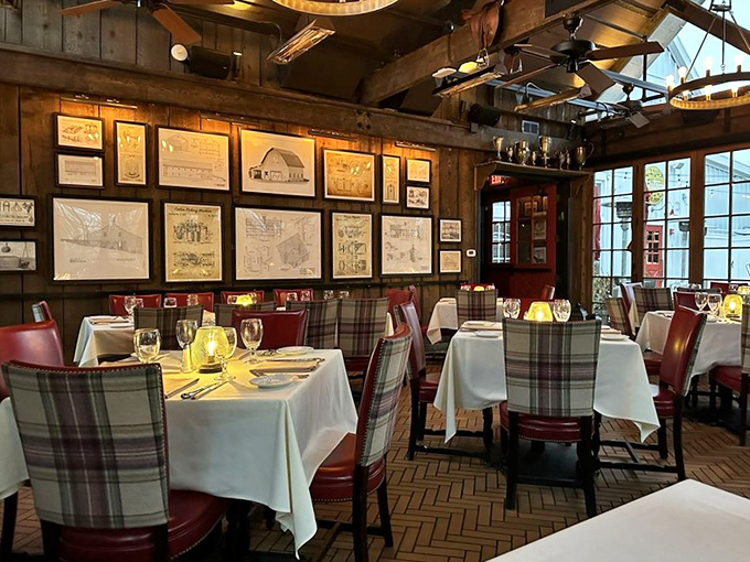 Rustic elegance defined: plaid chairs, white tablecloths, and historical drawings create an atmosphere where comfort meets sophistication without an ounce of pretension.