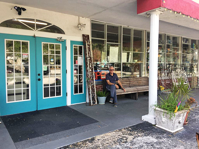 Those turquoise doors aren't just an entrance—they're time portals to decades past, complete with a welcoming bench for the shopping-weary.