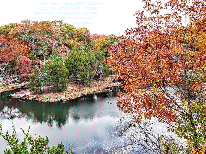 Fall transforms the quarry pond into a mirror of autumn splendor. The reflection doubles the magic of this hidden Missouri gem.