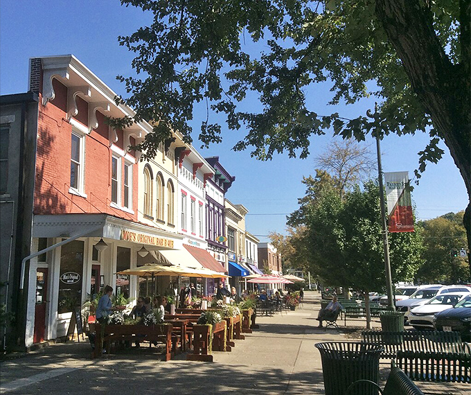 Colorful storefronts stand shoulder-to-shoulder along Broadway, where outdoor dining turns sidewalks into the town's most coveted social club.