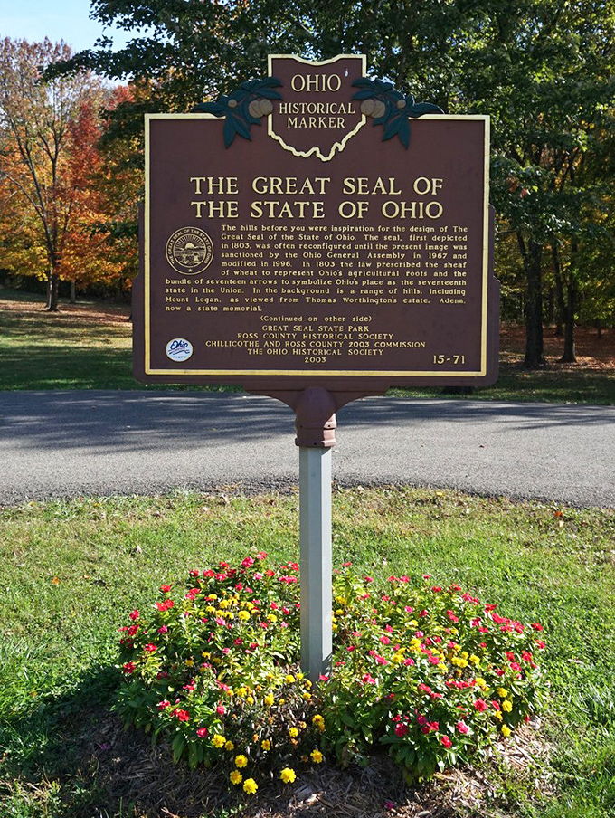 History stands tall amid autumn splendor. This marker tells the story behind Ohio's state seal—inspired by these very hills you can explore today.