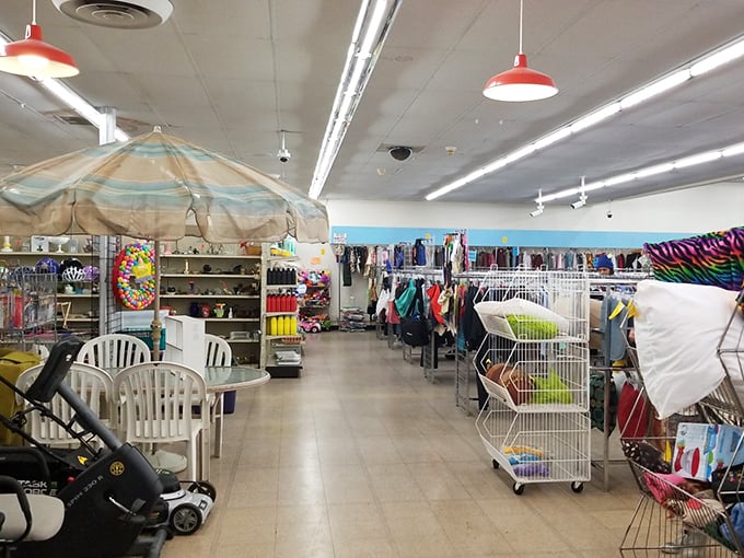 Beach umbrellas indoors? This colorful corner showcases summer gear alongside racks of potential wardrobe refreshers—thrift shopping at its most eclectic.
