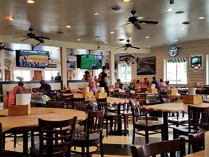 Inside, the bustling dining room hums with anticipation. Ceiling fans lazily spin overhead while hungry patrons plot their seafood strategies.