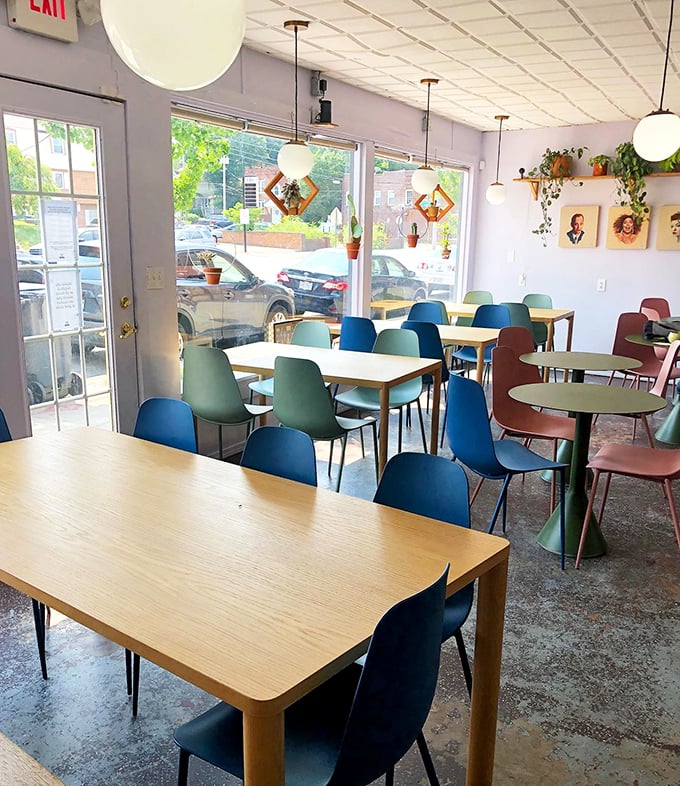Mid-century modern meets cozy café in this light-filled space. The colorful chairs aren't just stylish—they're an invitation to settle in and stay awhile.