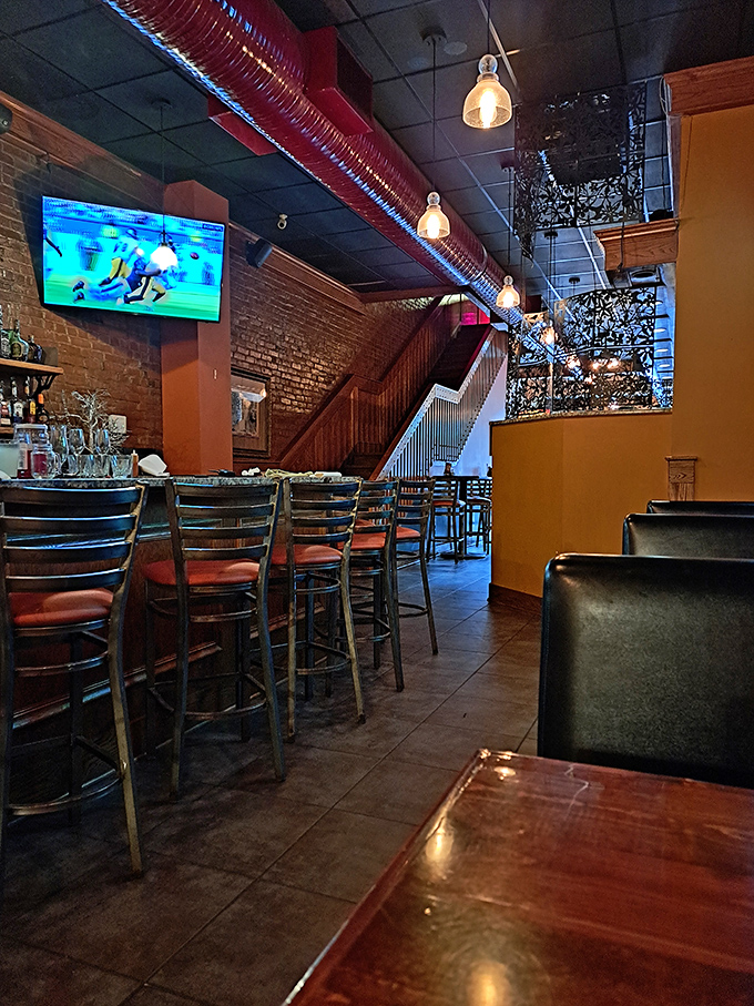 High ceilings, exposed brick, and pendant lighting create an atmosphere that's both rustic and refined—the perfect backdrop for comfort food that demands your full attention.