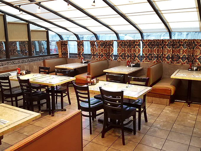 Classic diner ambiance with a twist—patterned curtains and comfortable booths create that perfect "stay awhile" atmosphere where breakfast dreams come true.