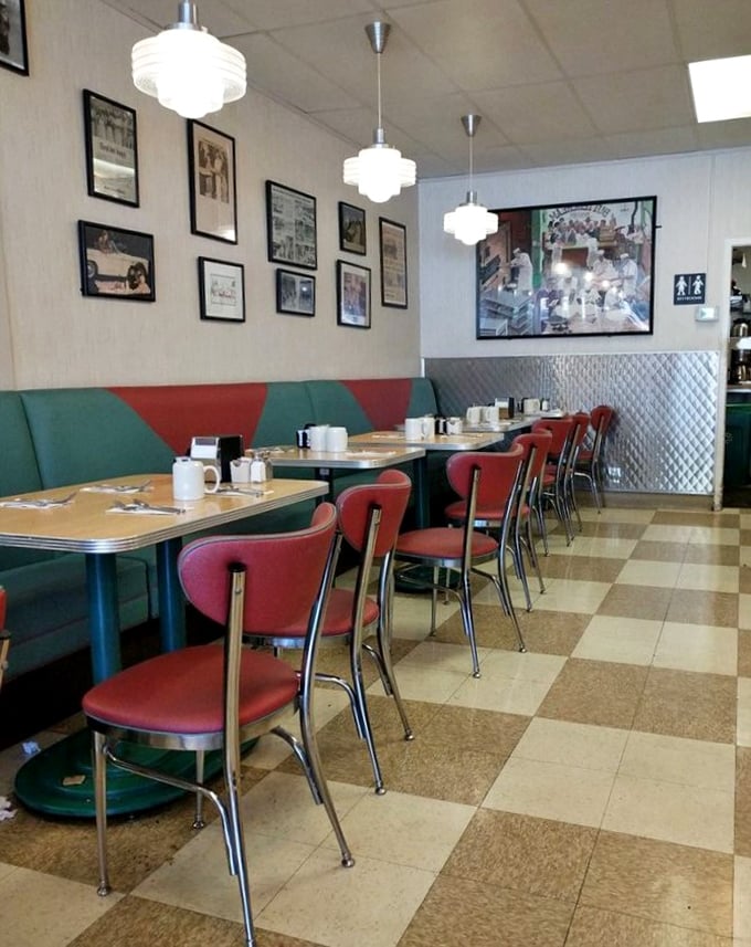 Classic diner aesthetics done right—checkerboard floors, vintage photos, and those red vinyl chairs that have cradled generations of happy eaters.
