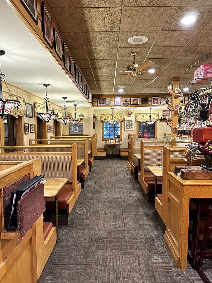 Wooden booths that have witnessed countless family celebrations and first dates. The vintage bikes aren't for delivery—they're conversation starters.