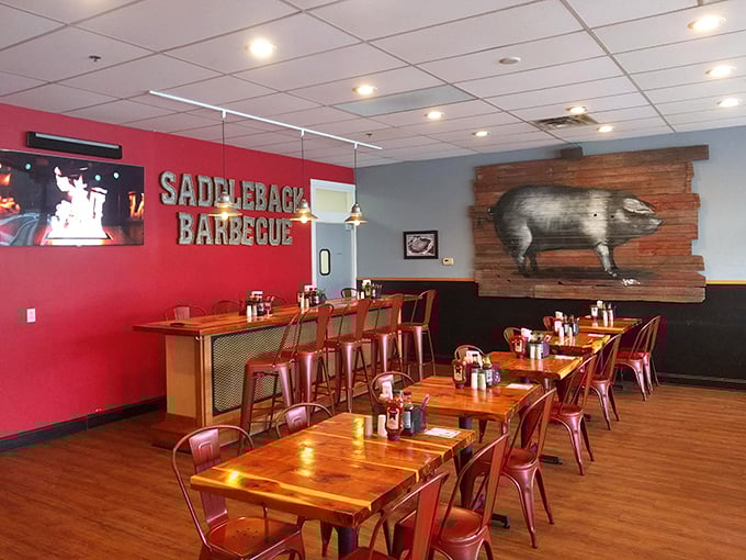 That pig artwork isn't just decoration—it's a mission statement. Red walls and wooden tables create the perfect backdrop for meat-induced euphoria.