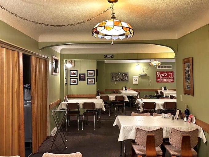 Stained glass pendant lights cast a warm glow over tables where countless "mmms" have been uttered. The green walls and wood accents feel like grandma's dining room—if grandma was a chicken whisperer.