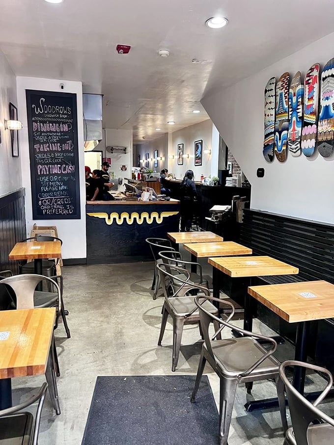 Industrial chic meets sandwich artistry in this cozy space where skateboard decks and butcher-block tables set the stage for serious eating.
