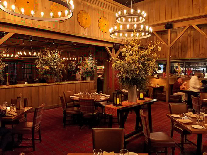Circular chandeliers cast a warm glow over plaid carpeting, creating the perfect marriage of rustic charm and upscale dining elegance.