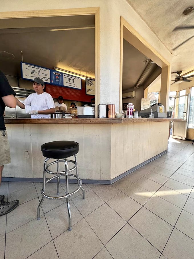 Simple counter seating where the real show happens right before your eyes – breakfast theater at its finest.