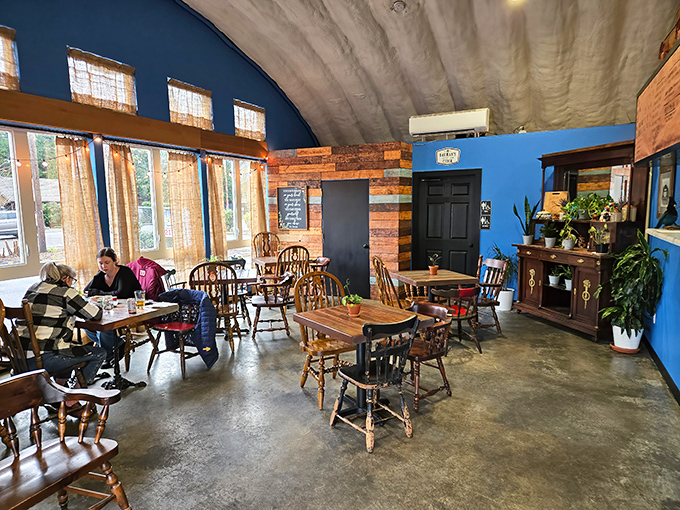 Mismatched wooden chairs and vibrant blue walls create that rare atmosphere where comfort meets character. Like your coolest friend's living room, but with better food.