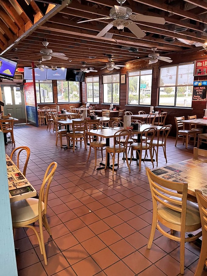 Classic Florida dining at its unpretentious best—wooden ceiling fans lazily spinning above terra cotta tiles that have welcomed countless sandy flip-flops.