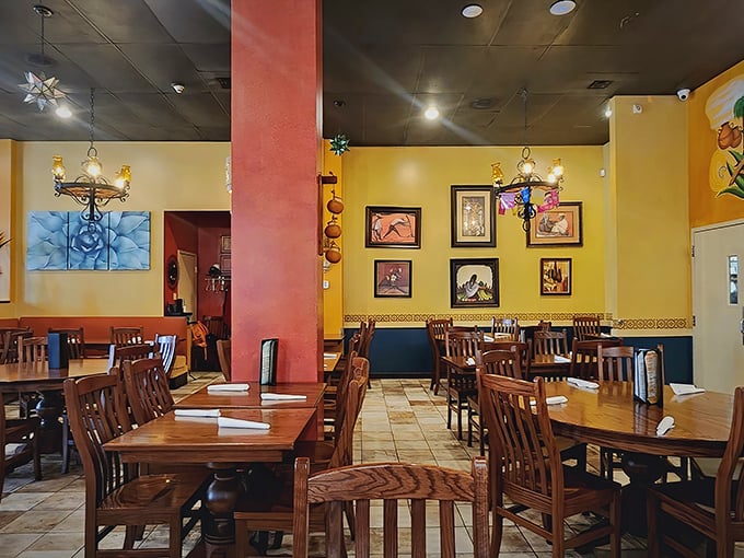 Warm yellow walls adorned with traditional artwork create that "abuela's dining room" feeling—comfortable yet special enough for celebration dinners.