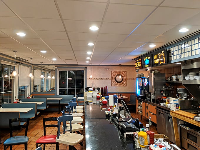 Classic blue booths and counter seating create that timeless diner atmosphere where conversations flow as freely as the coffee.