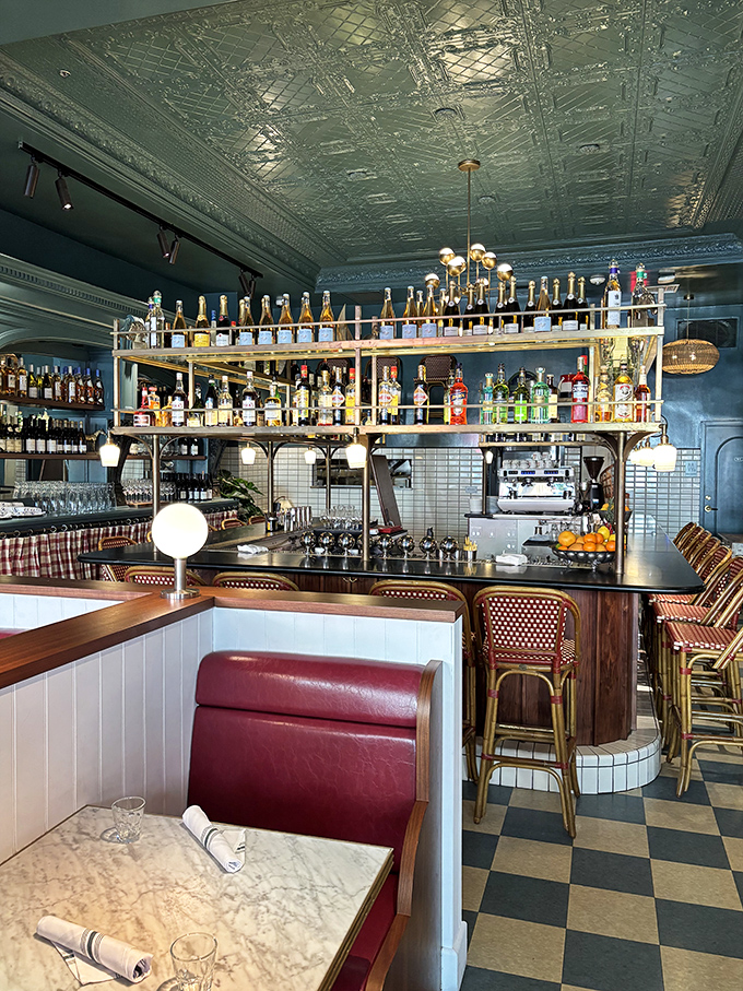 That ornate tin ceiling and perfectly arranged bar bottles aren't just decoration—they're a promise that someone here really cares about the details.
