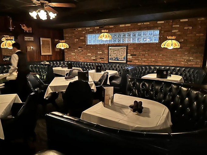 Classic steakhouse ambiance with navy leather booths and white tablecloths – like stepping into a time machine where smartphones don't exist and conversation reigns.