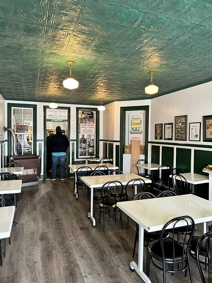 That pressed tin ceiling isn't just vintage charm—it's witnessed countless "first bite" moments of pure sandwich bliss beneath its mint-green patina.