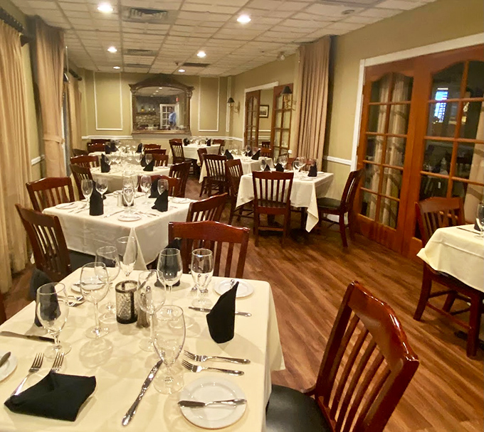 White tablecloths and warm wooden chairs create that perfect balance of elegance and comfort—fancy enough for celebration, relaxed enough for Tuesday.
