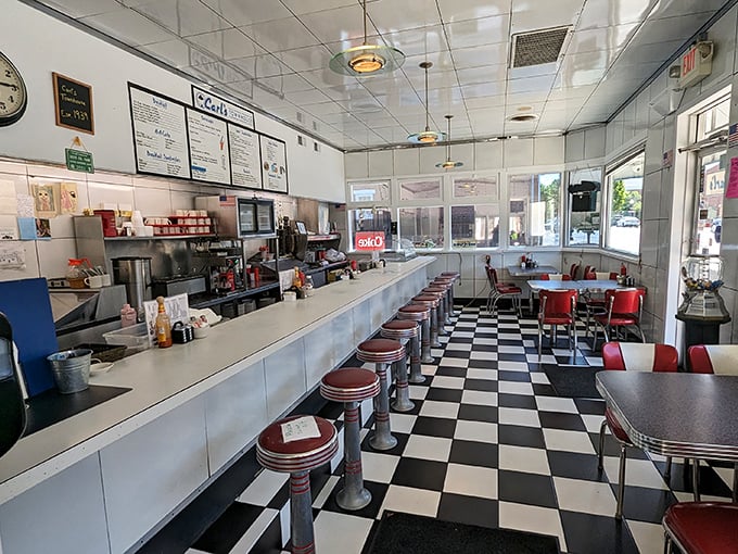 Classic Americana in every detail: the checkerboard floor, counter seating, and those red vinyl stools that have supported generations of satisfied diners.