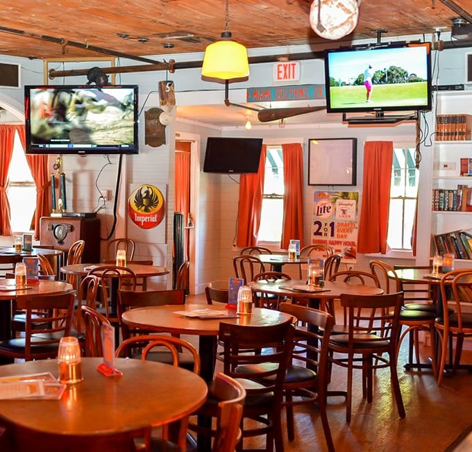 Inside Conchy Joe's, wooden tables and orange curtains create that perfect "I'm on vacation even though I live here" vibe that Floridians treasure.