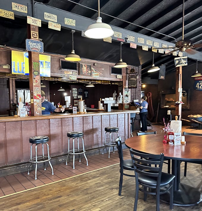 License plates adorn the ceiling while simple wooden counters welcome hungry patrons. This isn't Instagram-chic décor—it's the real BBQ joint aesthetic where flavor trumps fashion.