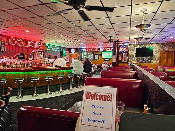 Step inside and time stands still. The neon glow, red vinyl booths, and "Please Seat Yourself" sign tell you this place means delicious business.