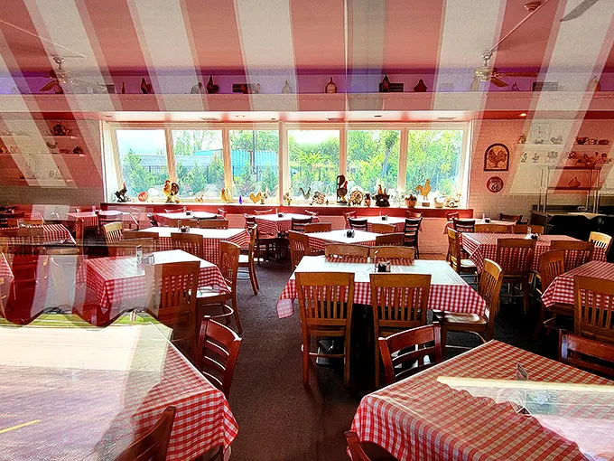 Red and white checkered tablecloths set the stage for culinary nostalgia – this isn't Instagram-bait décor, it's the real deal that's been charming diners for generations.