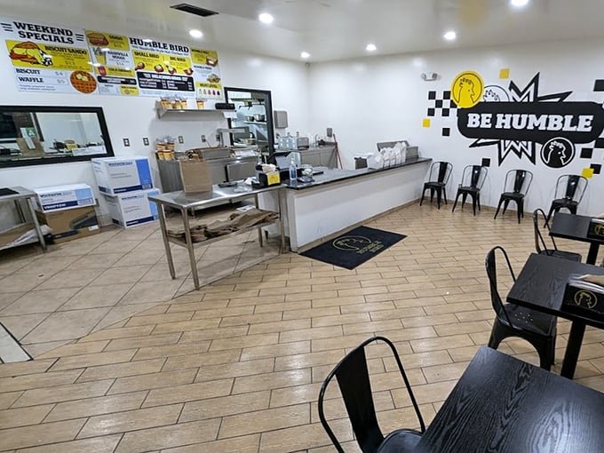 Minimalism with purpose—black chairs, clean counters, and that bold "BE HUMBLE" graphic remind you they're focused on what matters: the chicken, not fancy decor. 