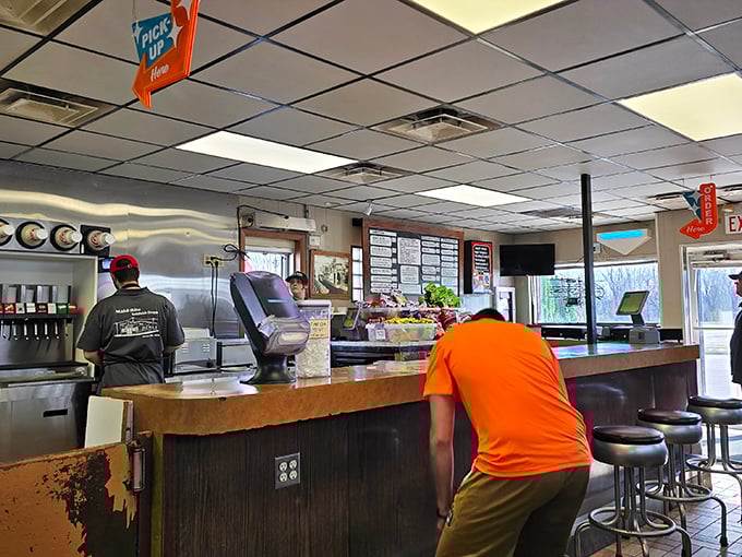 Step inside where fluorescent lights illuminate culinary magic happening behind that well-worn counter every single day.