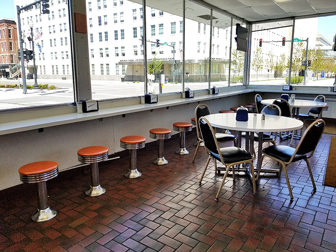 Classic counter seating with those iconic orange-topped stools – where strangers become friends and everyone's united by the pursuit of perfect chili.