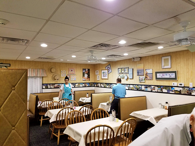 Wood paneling, Windsor chairs, and white tablecloths create the perfect backdrop for comfort food conversations. This isn't trendy décor—it's timeless hospitality. 