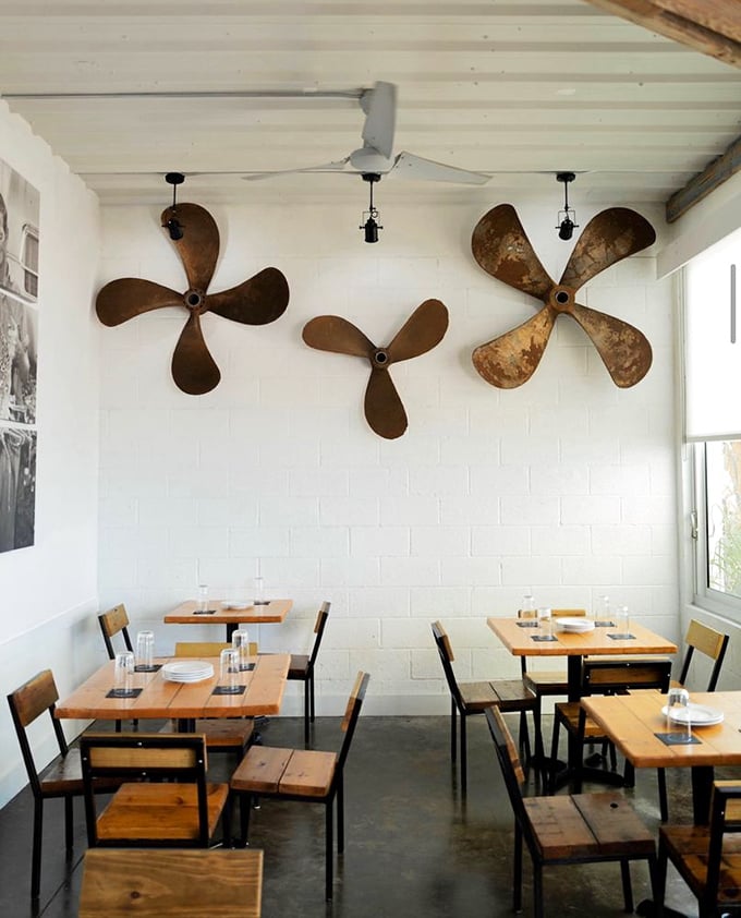 Nautical history adorns the walls with vintage boat propellers—silent storytellers of maritime adventures past while you create new ones over dinner.