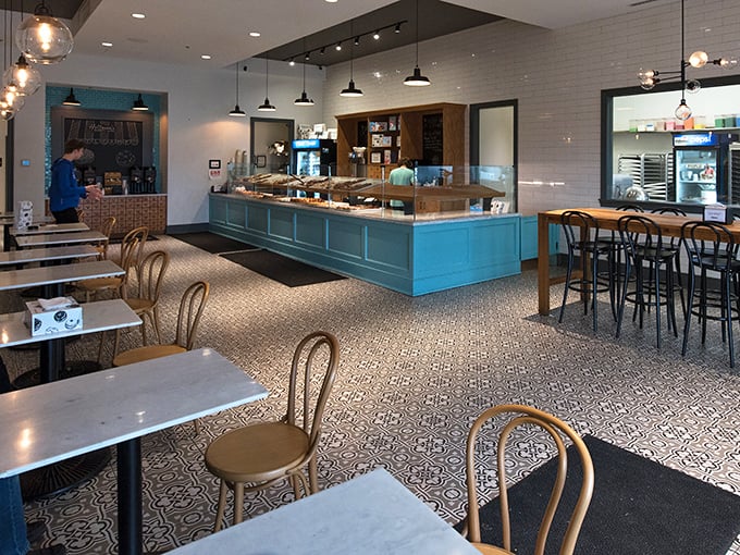Modern meets nostalgic in this thoughtfully designed space where the real stars—those glorious donuts—take center stage behind gleaming glass.
