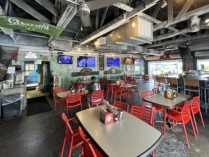 Inside, the industrial-meets-beach-shack vibe creates the perfect backdrop for seafood feasting, with exposed beams and those signature red chairs inviting you to stay awhile.