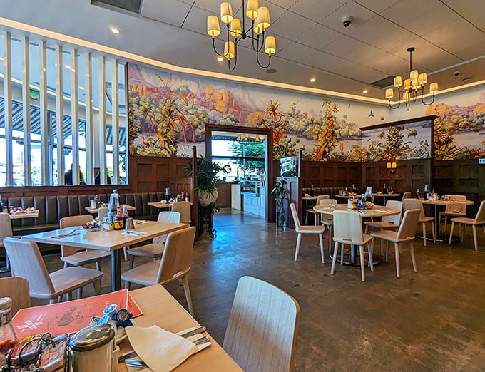 Warm wood, colorful murals, and just the right lighting – this dining room feels like the breakfast equivalent of a perfect hug.