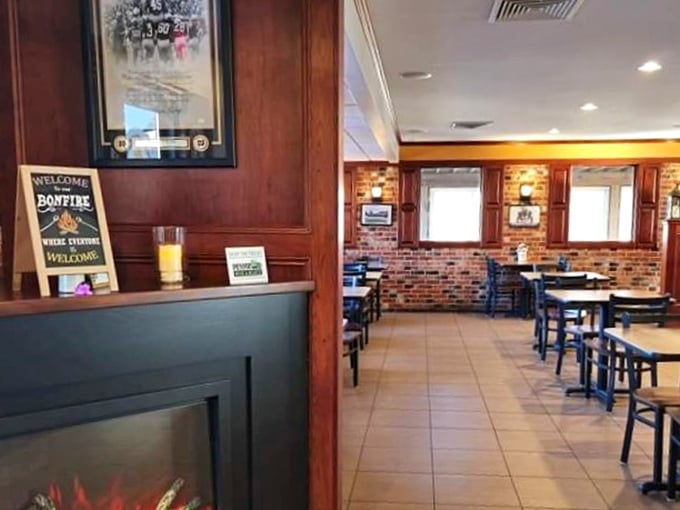 Warm wood paneling and brick accents create that perfect "come as you are" atmosphere where napkins aren't just provided—they're absolutely necessary.