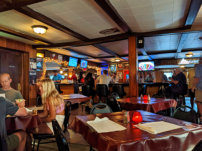 Step inside and time stands still – wood paneling, red tablecloths, and the warm glow of conversation create the quintessential Wisconsin supper club atmosphere that no trendy bistro could replicate.