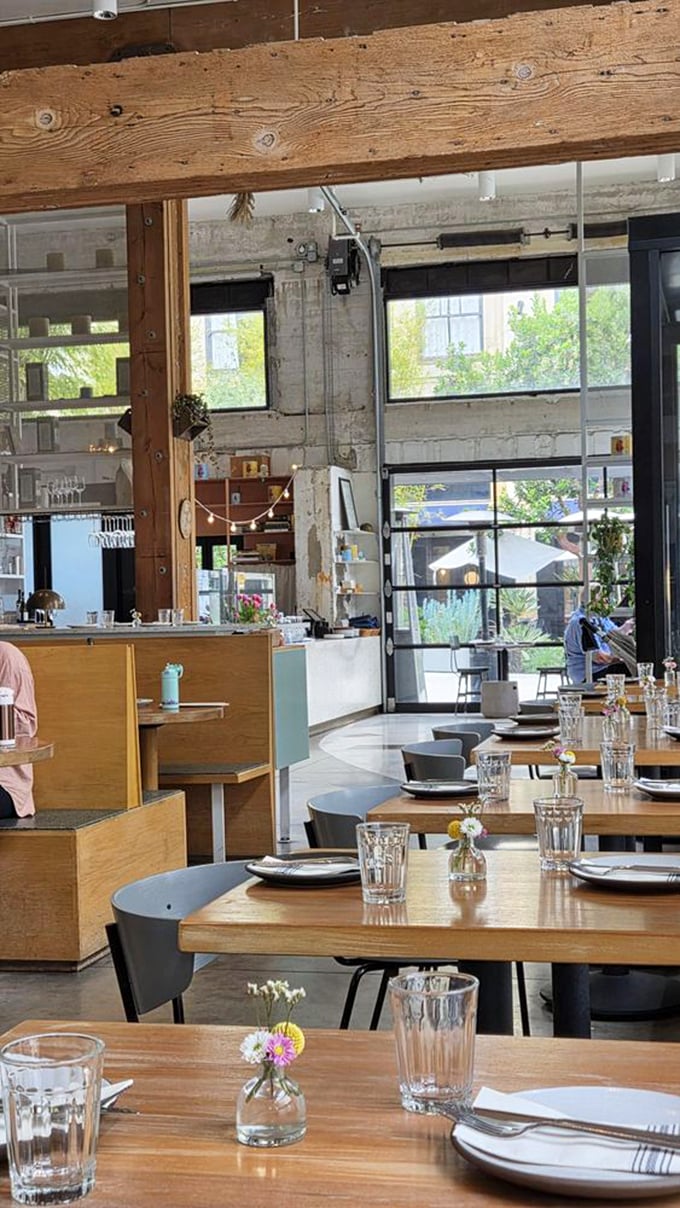 Sunlight streams through floor-to-ceiling windows, illuminating wooden beams and minimalist tables. This isn't just dining—it's a cathedral of carbs.