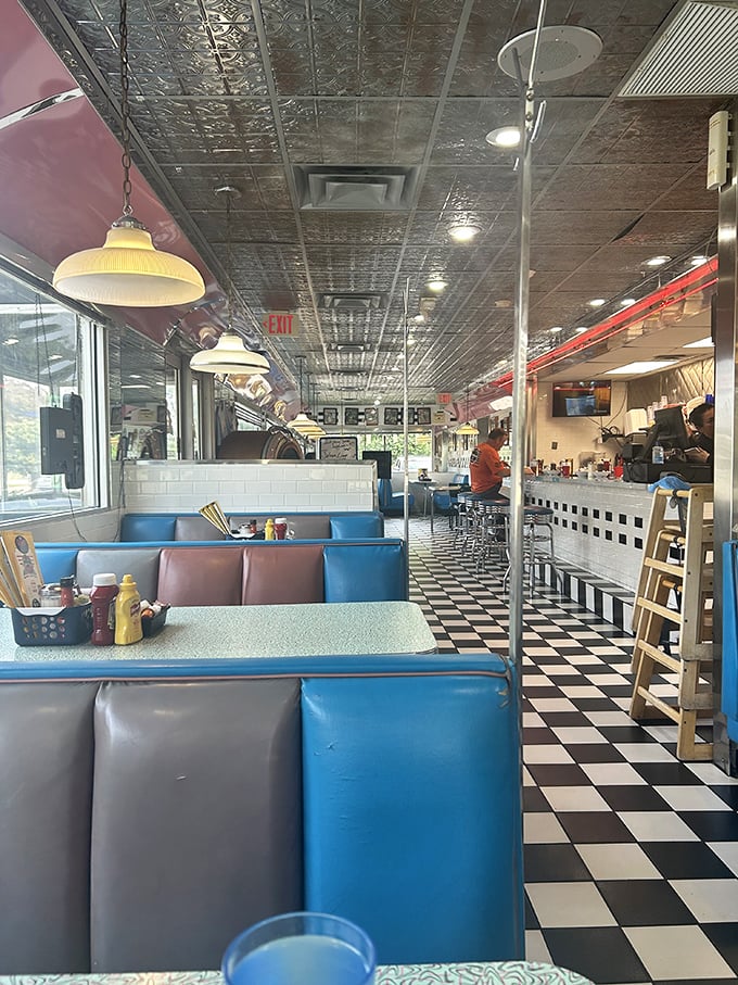 Classic blue and pink vinyl booths, checkerboard floors, and pressed tin ceilings—this isn't decoration, it's a commitment to the art of diner perfection.